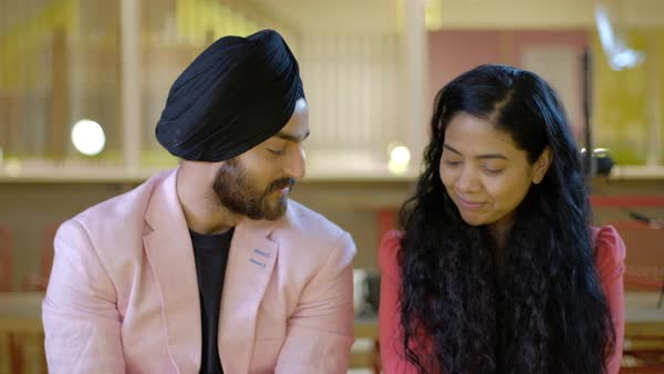 Beautiful Indian couple in love, turbaned Sikh and curly haired woman ...