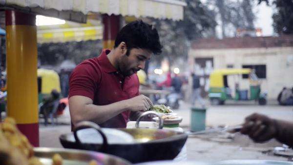 Man eating street food at a food stall - Stock Video Footage - Dissolve