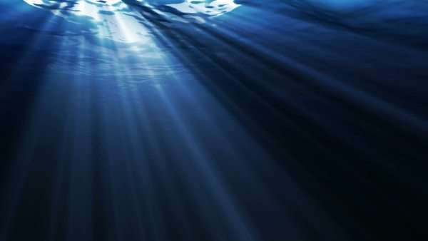 Underwater ocean waves, with light rays. - Stock Video Footage - Dissolve