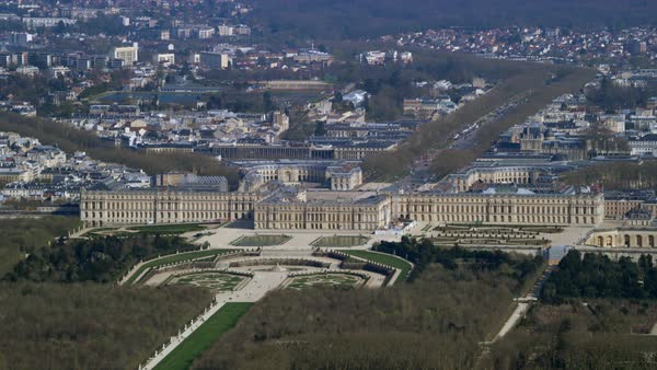 Aerial view above the palace of Versailles with landscaped gardens and ...