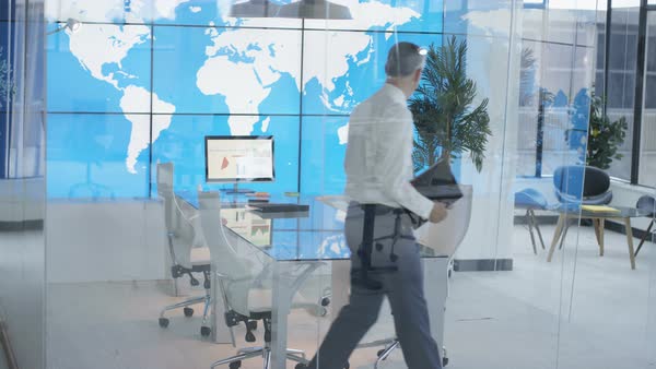 International business team in a meeting, looking at world map on video ...