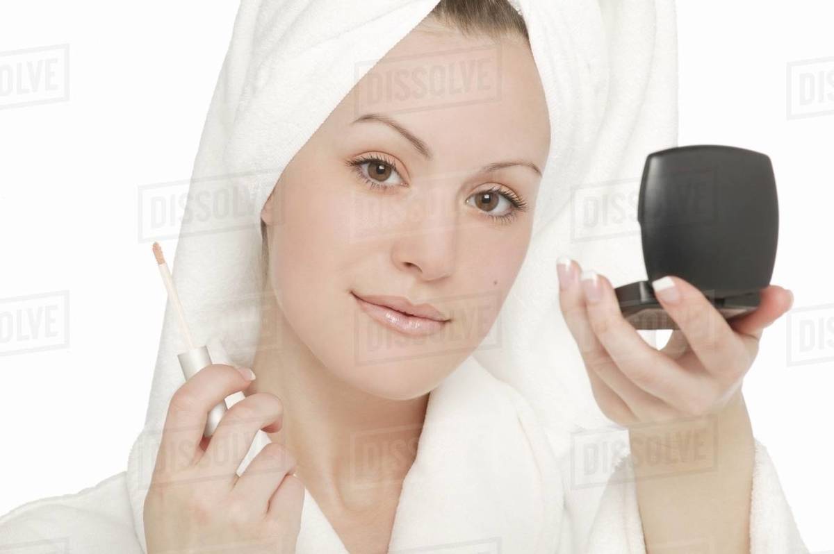 Woman Applying Makeup - Stock Photo - Dissolve