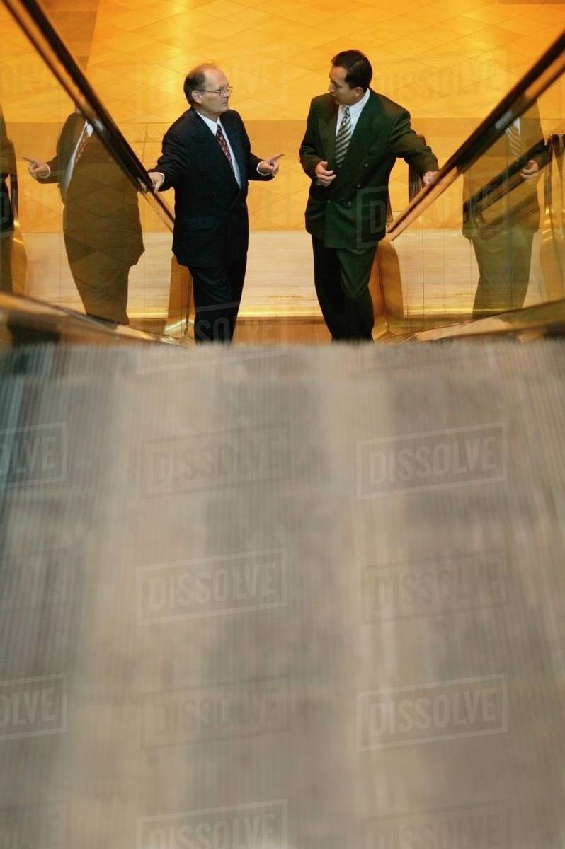 Two Men Have A Discussion On An Escalator - Royalty-free Stock Photo ...