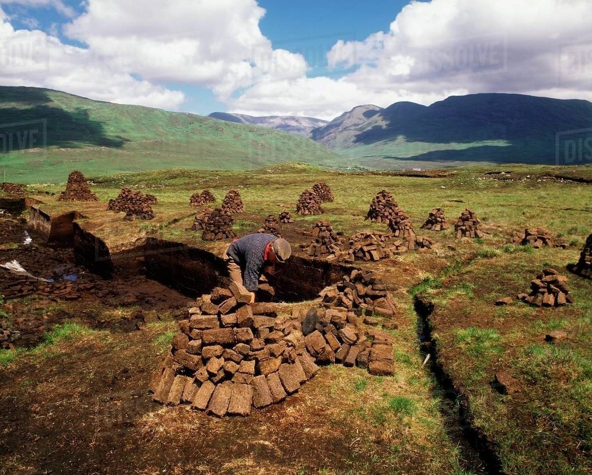 Co Galway, Ireland; Turf Cutting - Stock Photo - Dissolve