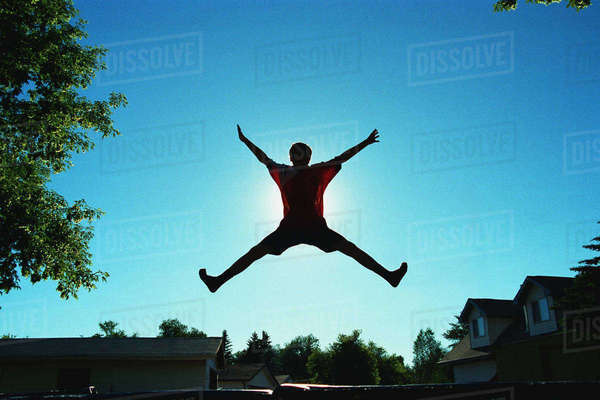 Silhouette Of Person Doing Star Jump - Royalty-free Stock Photo | Dissolve