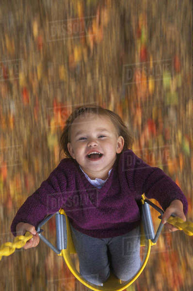 Child On Swing - Stock Photo - Dissolve