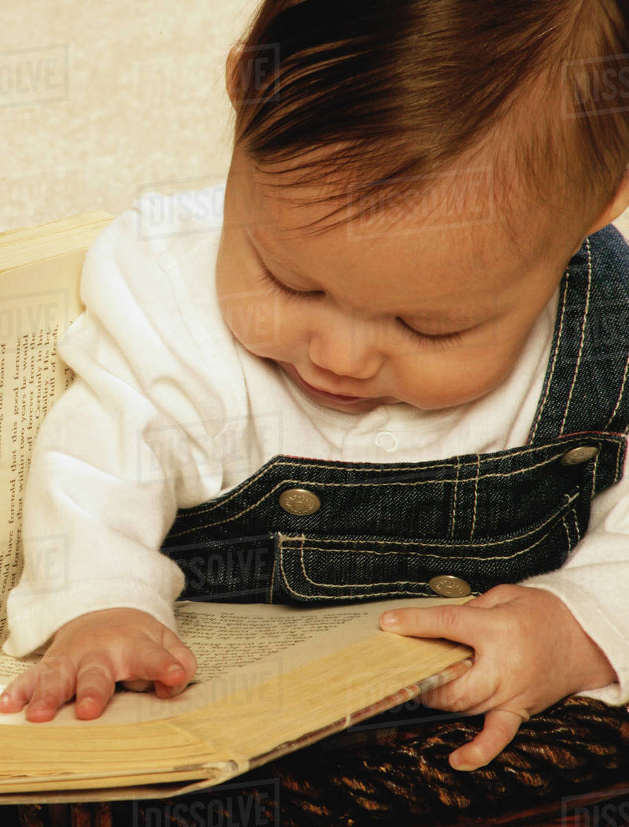 Baby Reading A Book - Stock Photo - Dissolve