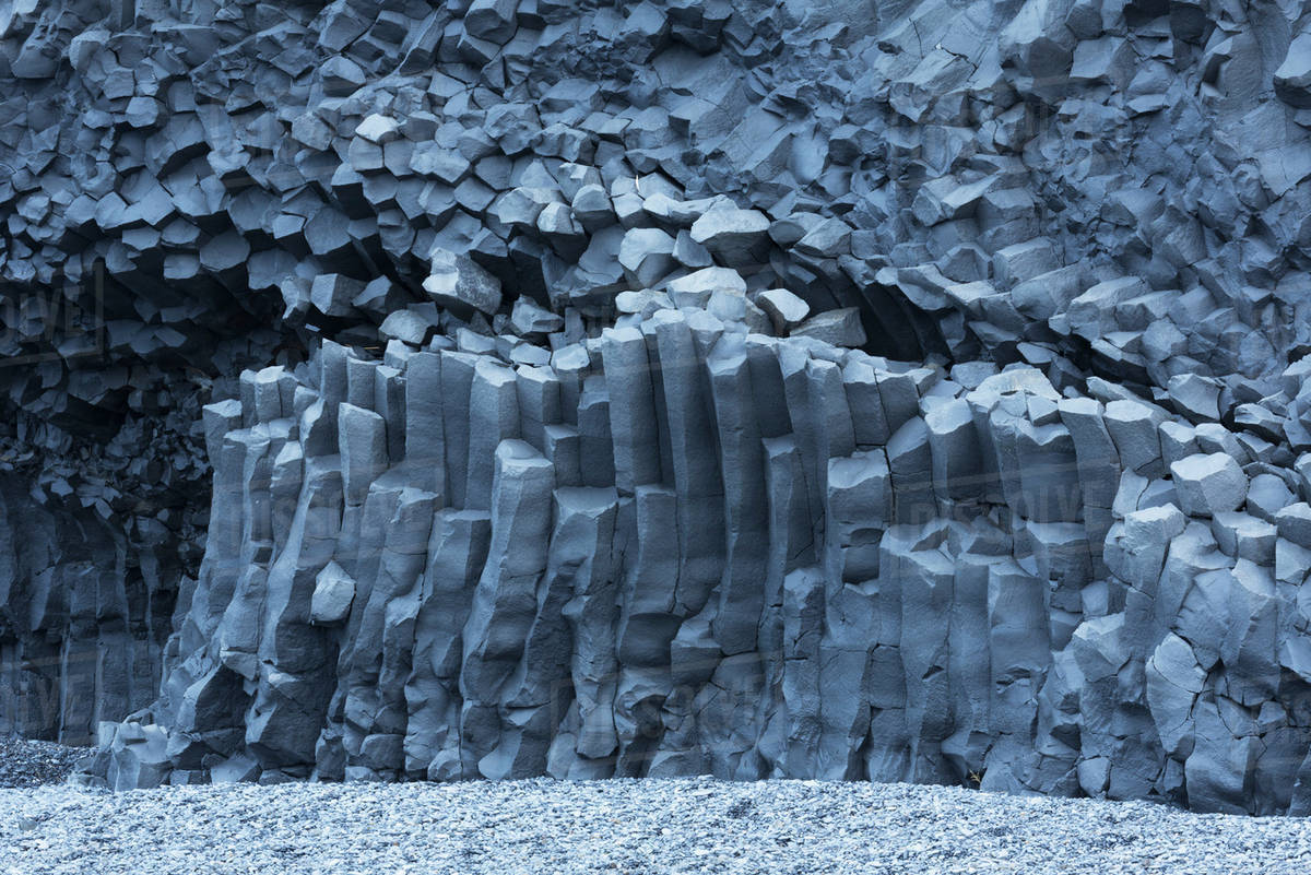 Hexagonal basalt columns rise out of the earth near the beaches of Vik ...