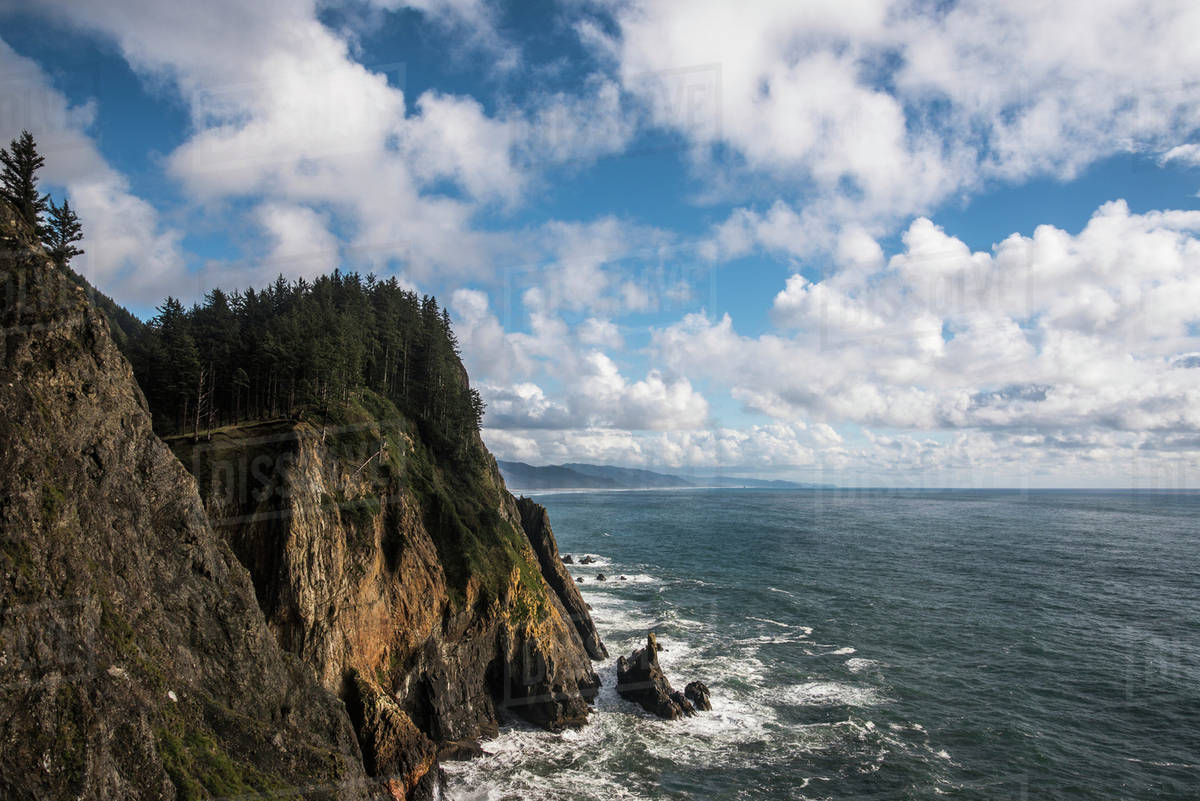 Scattered clouds pass over the Oregon coast; Manzanita, Oregon, United ...