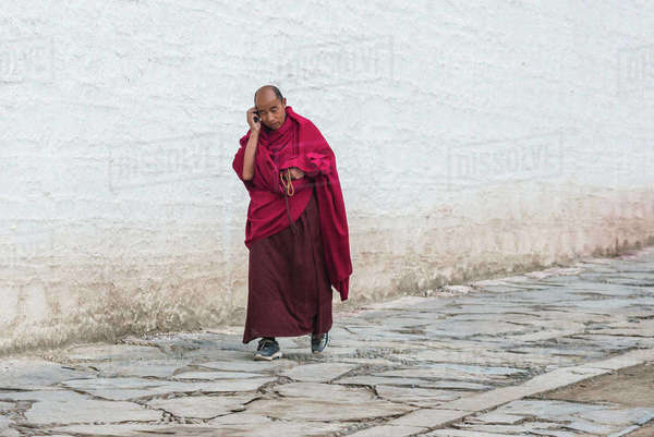 The Monk At Tibetan Labrang Monastery Is Talking On Mobile Phone; Tibet ...