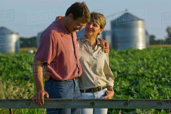 Agriculture - Husband and wife farmers in their mid growth soybean ...