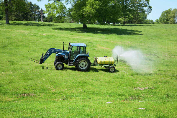 Agriculture - Spraying herbicide on a pasture used for grazing beef ...