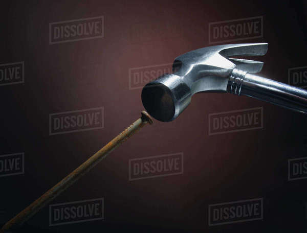 Hammer Hitting The Nail - Stock Photo - Dissolve