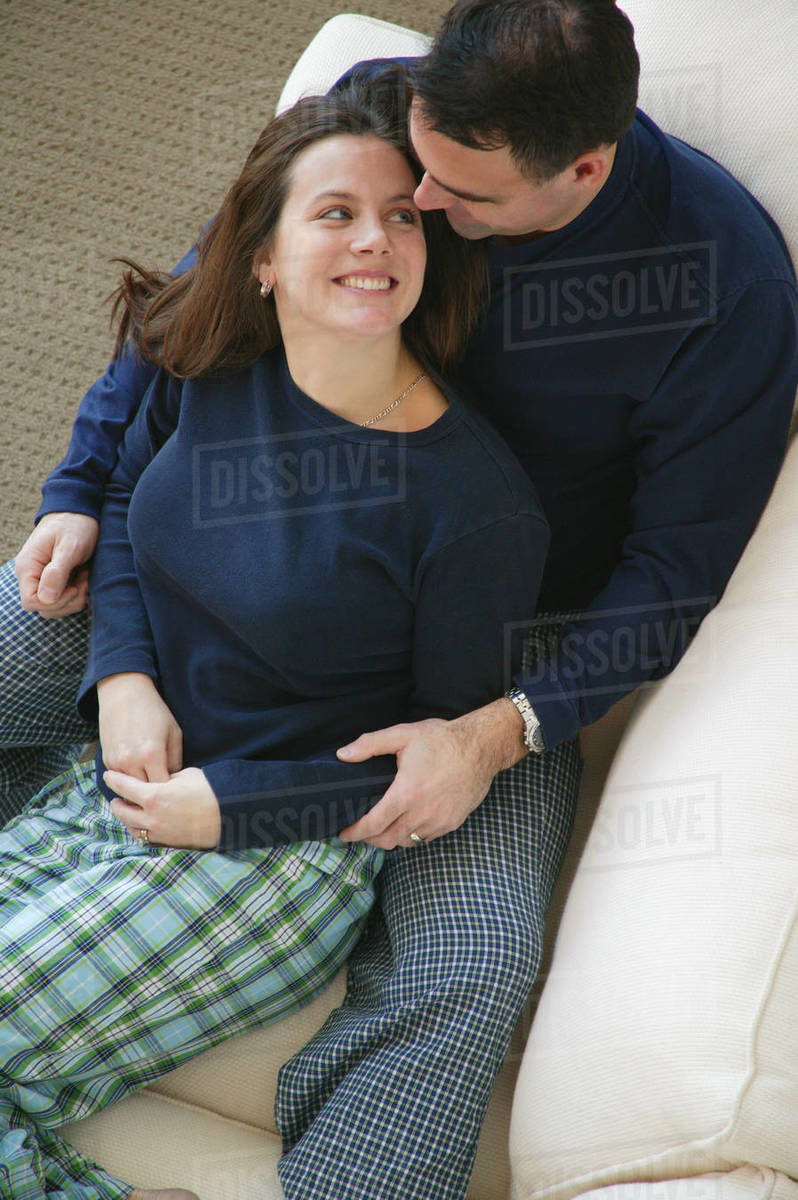 Couple Snuggles On Sofa - Royalty-free Stock Photo | Dissolve