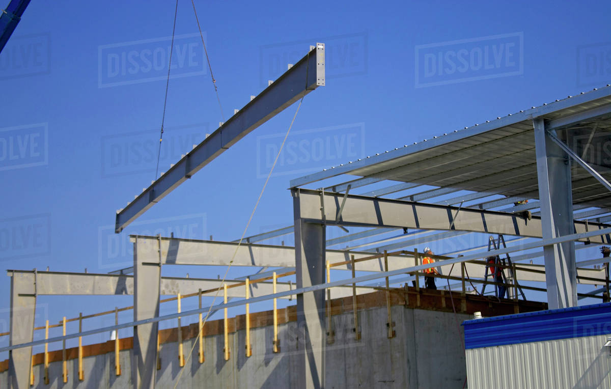 Steel Girder Being Lifted Onto Roof Of Building; Canada, Ontario ...