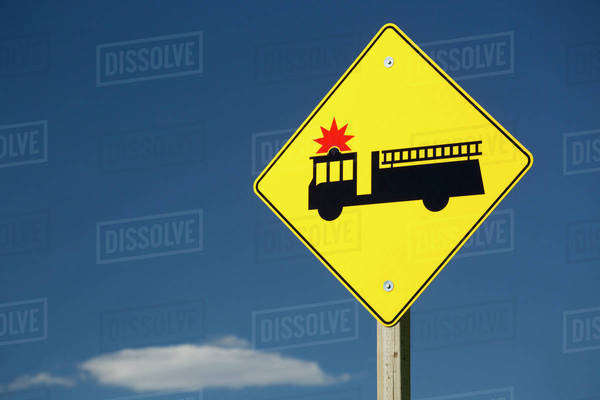 Close up of fire truck road sign with blue sky and cloud; Bragg Creek ...