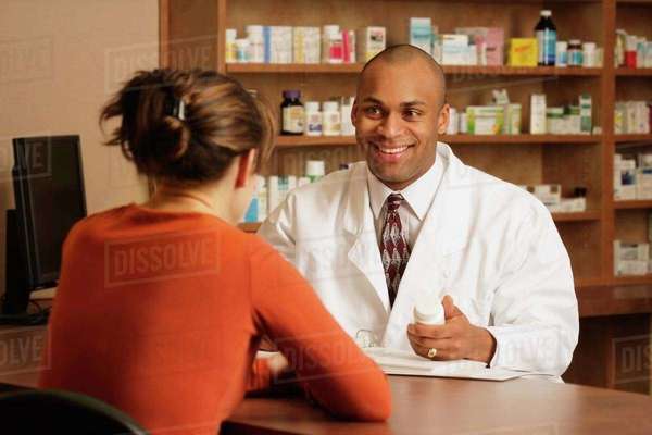 Pharmacist With Patient - Royalty-free Stock Photo | Dissolve