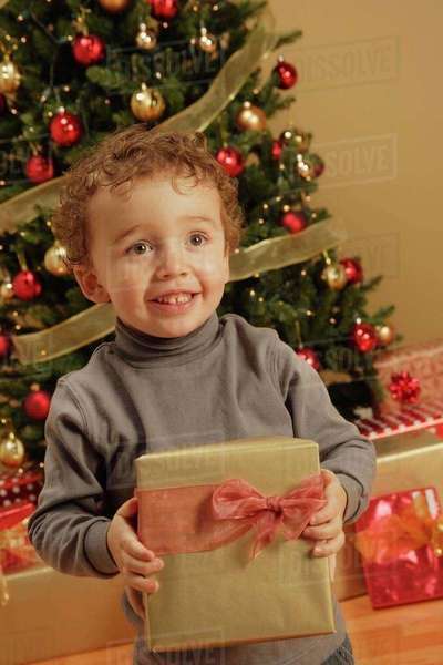 Child With Present - Stock Photo - Dissolve