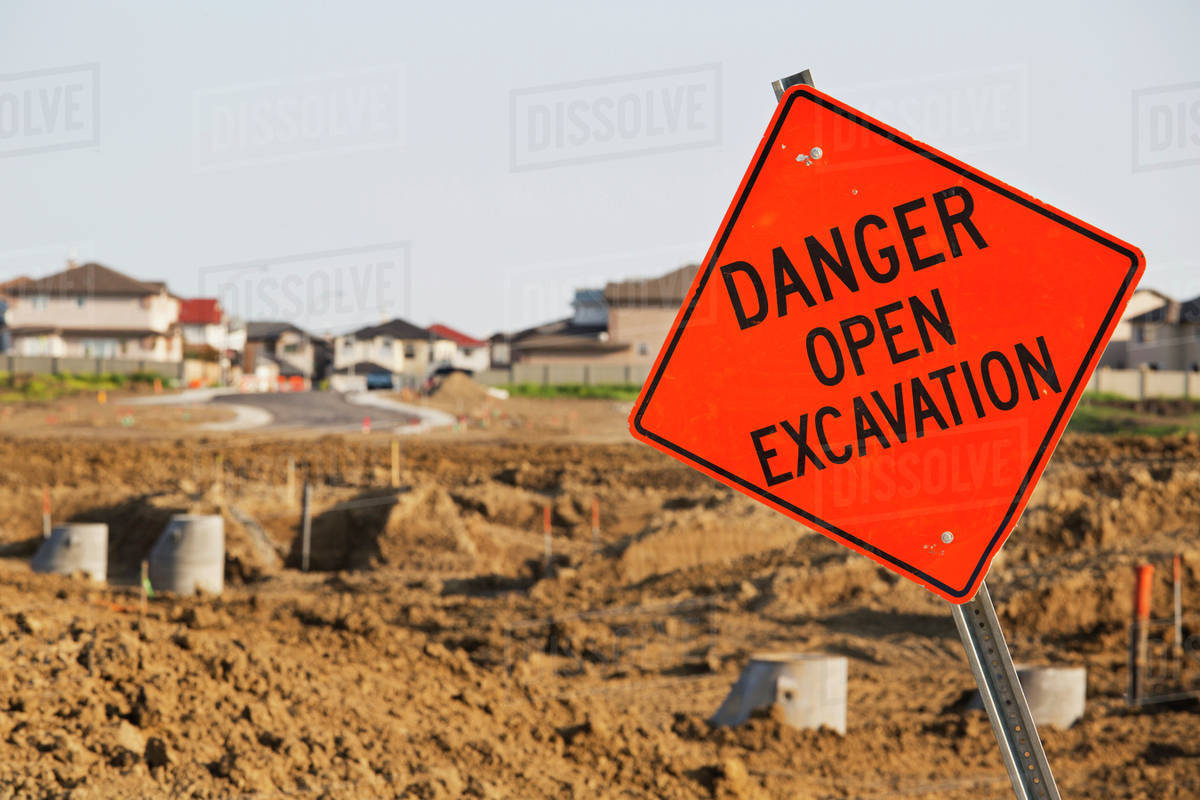 Sign warning of danger at the construction site of new development; Edmonton, Alberta, Canada ...