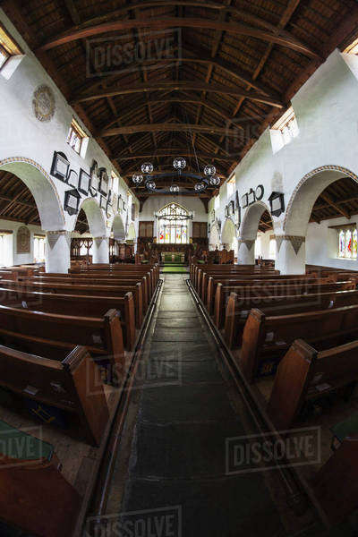Interior of a church with a centre aisle and wooden pews; Hawkshead ...