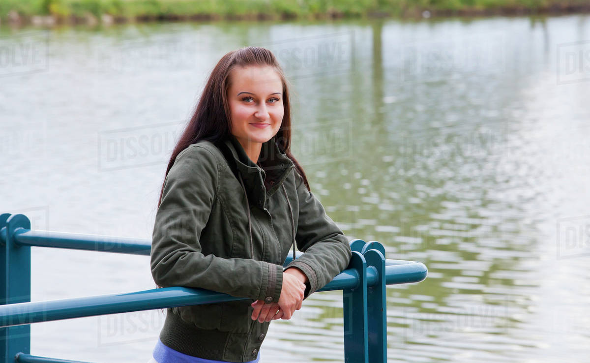 Portrait of a young woman on a pier; St. Albert, Alberta, Canada ...