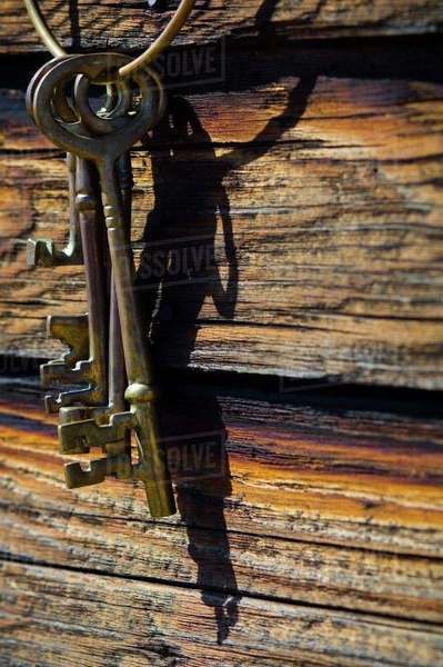 Old-Fashioned Keys On Log Wall - Stock Photo - Dissolve