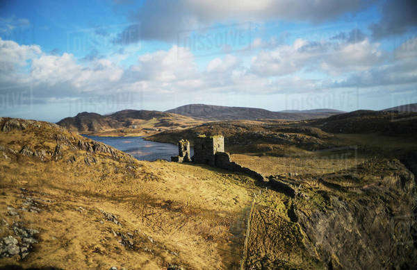 Arid mountainous landscape with ruins of wall and building in West Cork ...