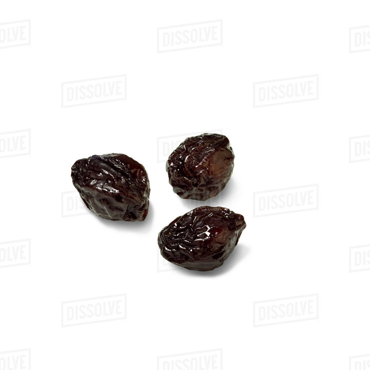 Dried prunes on a white background - Stock Photo - Dissolve