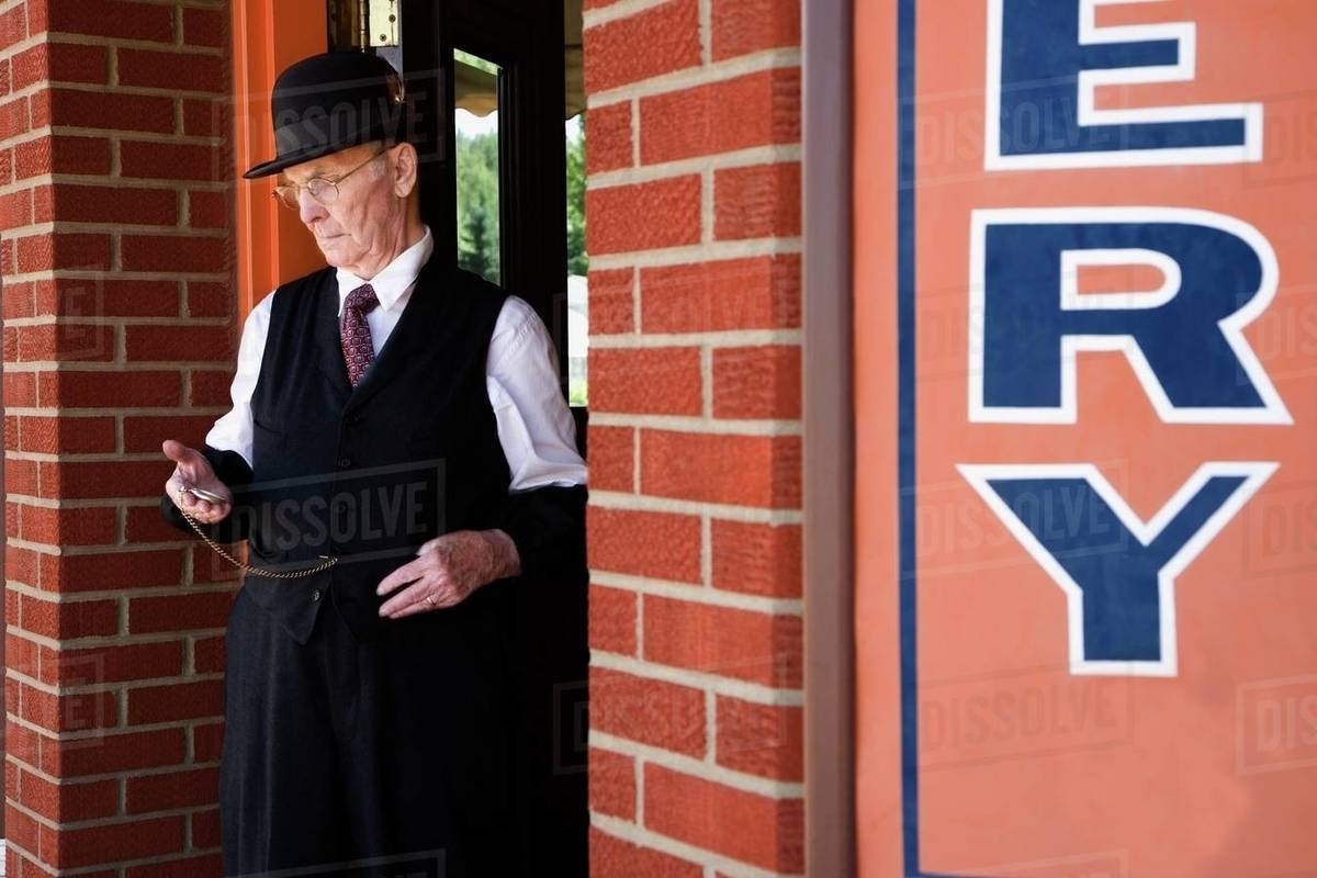 Man In Doorway Of Building Looking At Watch - Royalty-free Stock Photo ...