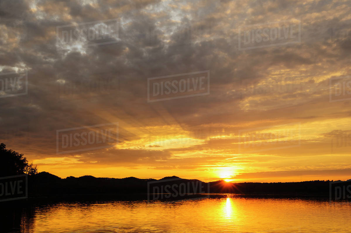 Golden sunlight reflecting on cave run lake at sunset;Morehead ...