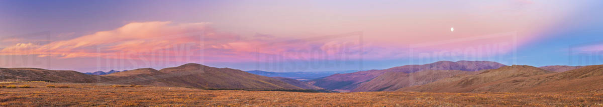 Alpenglow lights the clouds above eagle summit along the steese highway ...
