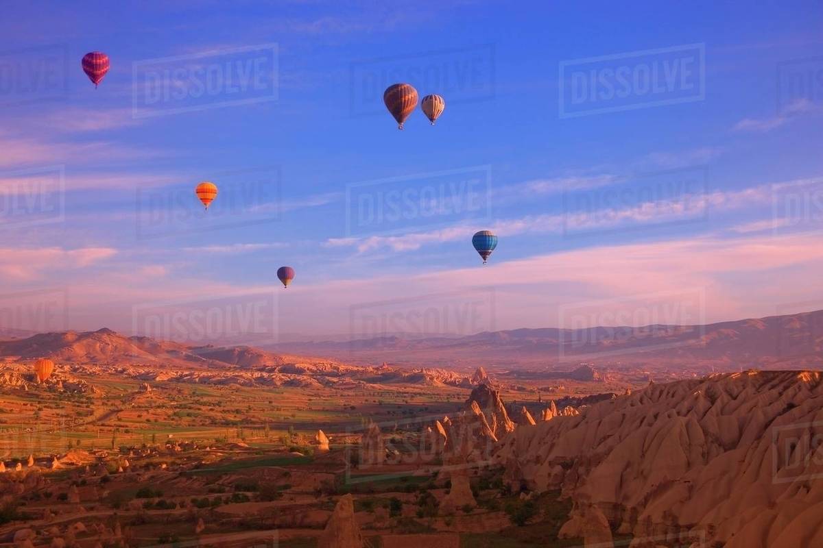 Hot Air Balloons Floating Over The Badlands, Cappadocia, Turkey ...
