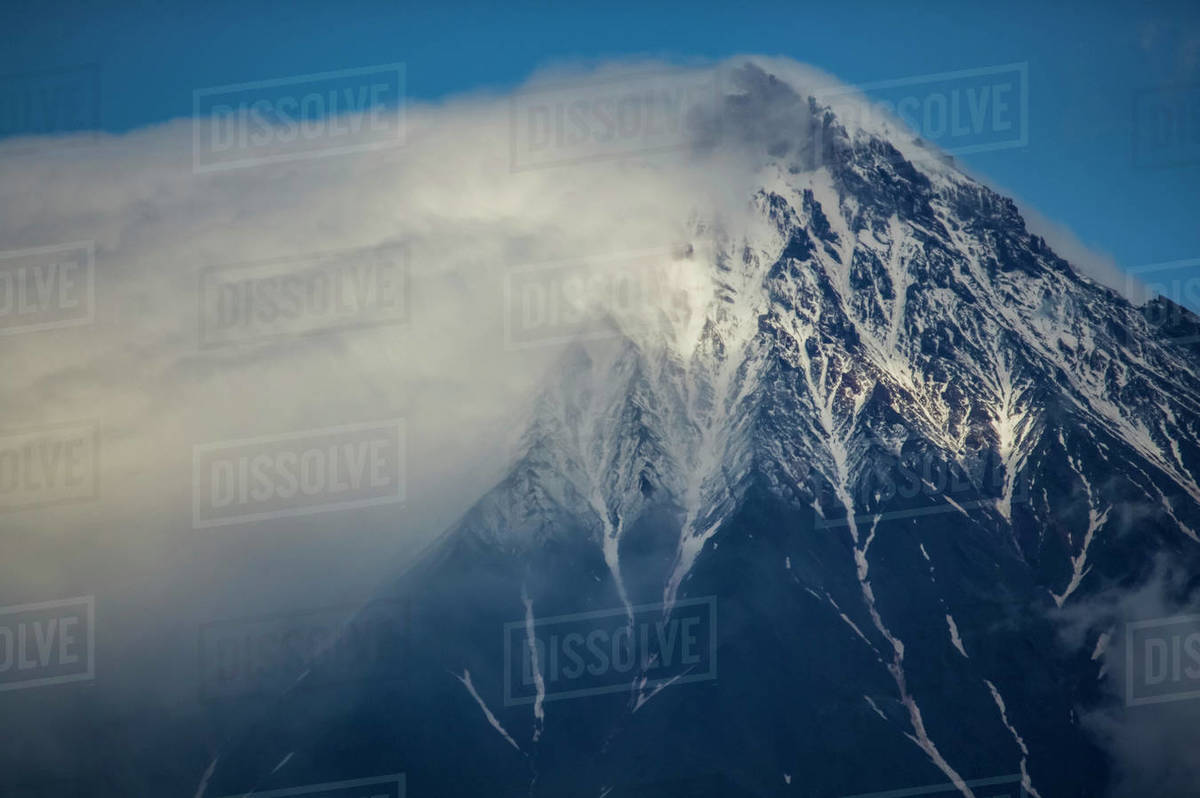 Clouds roll over Kronotsky Volcano; Kronotsky Zapovednik, Kamchatka ...