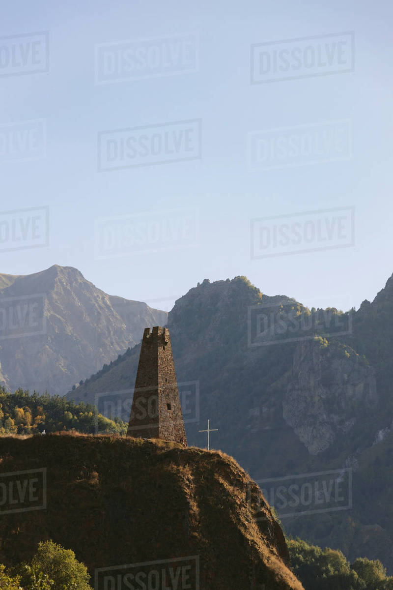 Truso Gorge with cross and watchtower on the edge or a mountainside ...