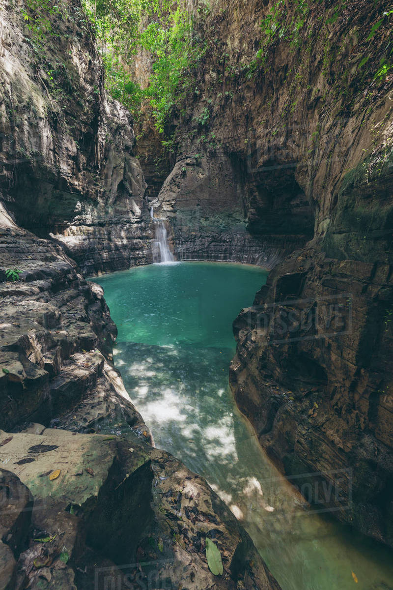 Stunning lagoon and waterfall at Air Terjun Wai Marang on the island of ...