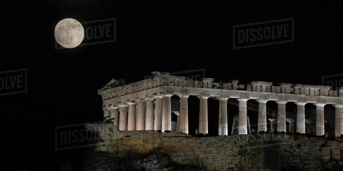 Illuminated Parthenon at night with a full moon over the Acropolis of ...