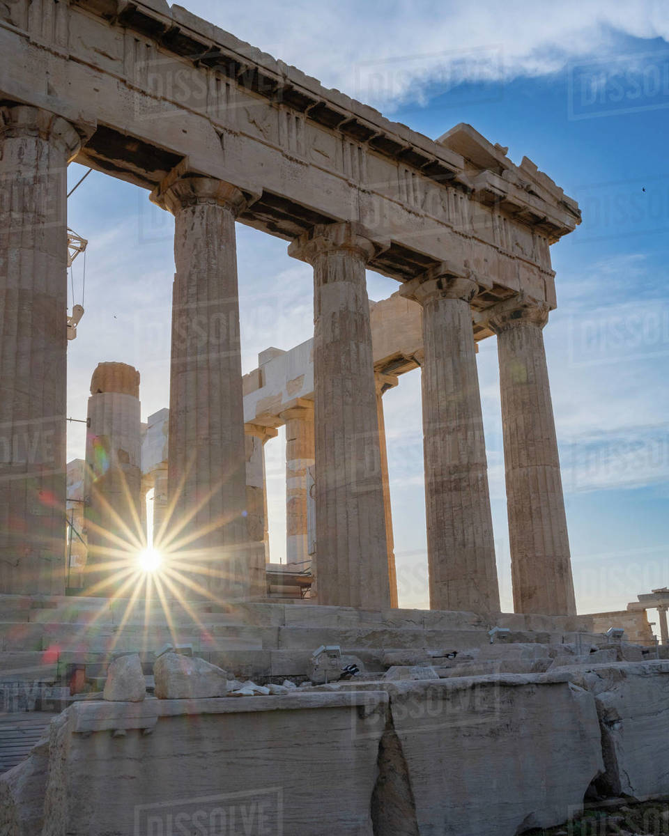 Close-up view of the columns of The Parthenon against a blue, cloudy ...