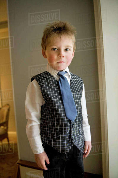 Young boy in formal wear poses for a photograph; Lincoln, Nebraska ...