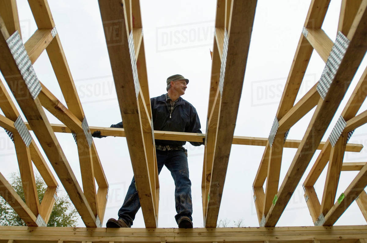 Worker framing a building on a construction site; Lincoln, Nebraska ...