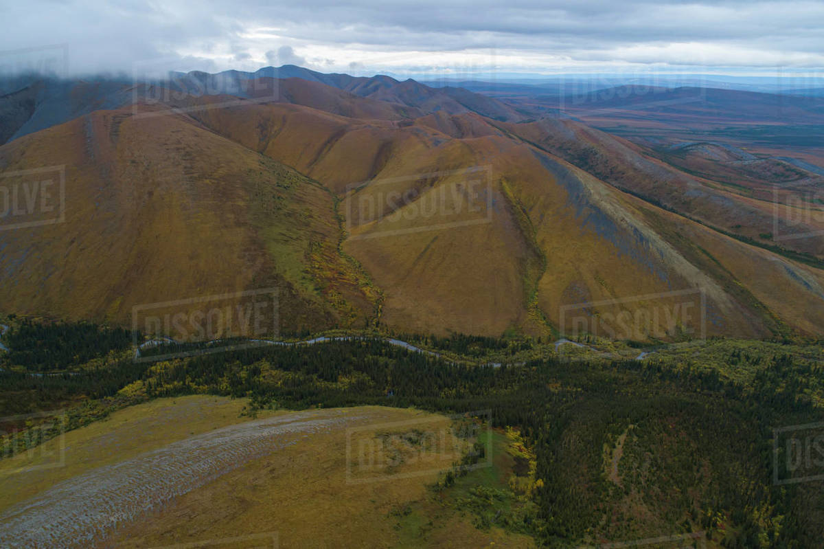 Aerial photograph of a river winding through the Richardson Mountains ...