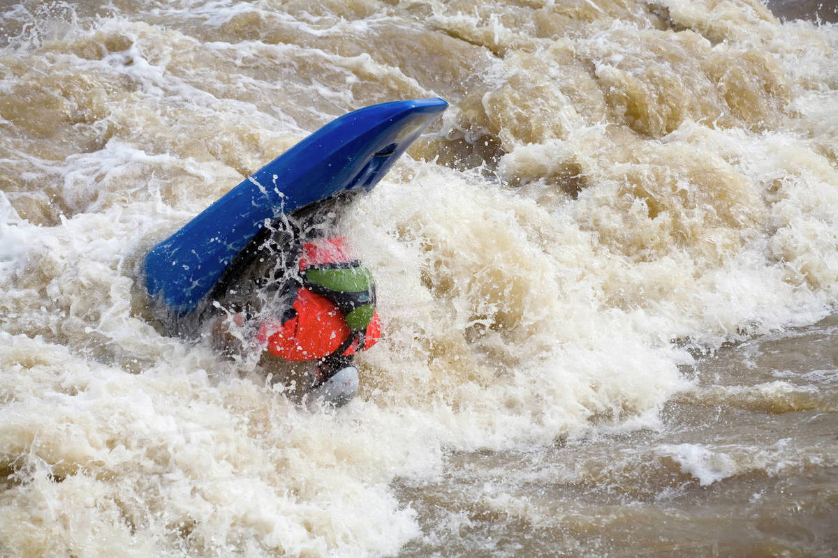 Kayker flips over while paddling through strong river rapids.; Potomac ...