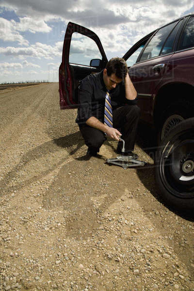 Man Changing Flat Tire - Royalty-free Stock Photo | Dissolve