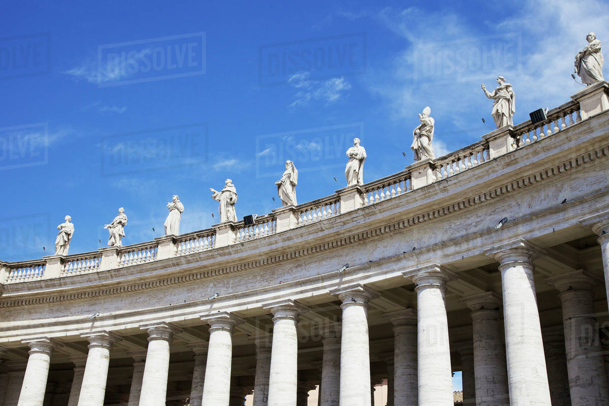 Statues and tuscan colonnades, St. Peter's Square; Vatican City, Italy ...
