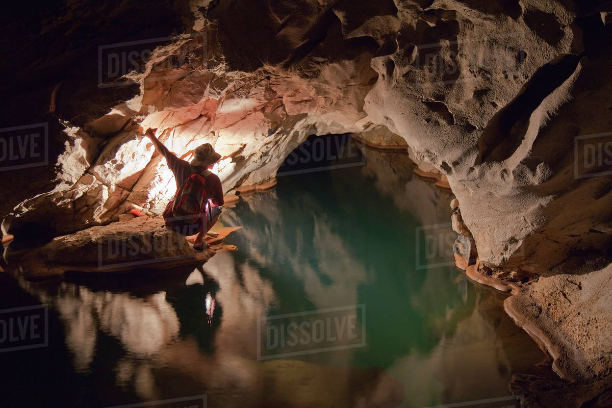 A Filipino Tour Guide Holds A Lantern Inside Sumaging Cave Or Big Cave ...