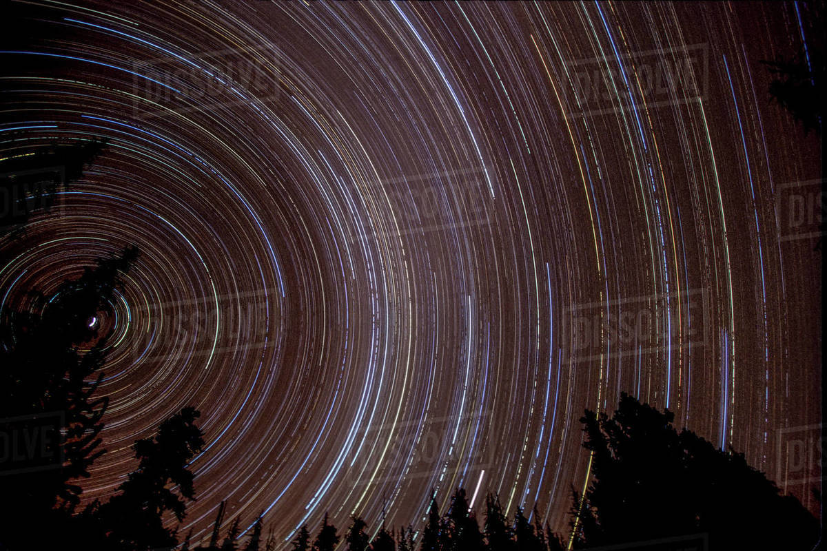 Long exposure of stars creating star track patterns in the night sky ...
