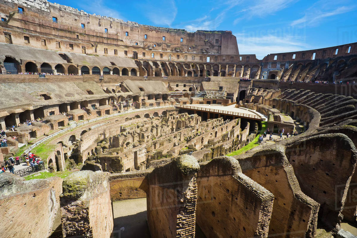 Overview of the interior of the iconic Colosseum against a blue sky ...