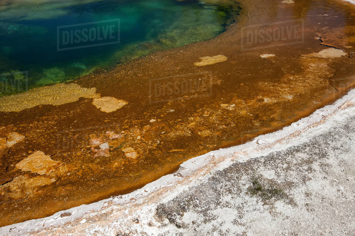 White and colorful mineral deposits from geothermal features in a ...