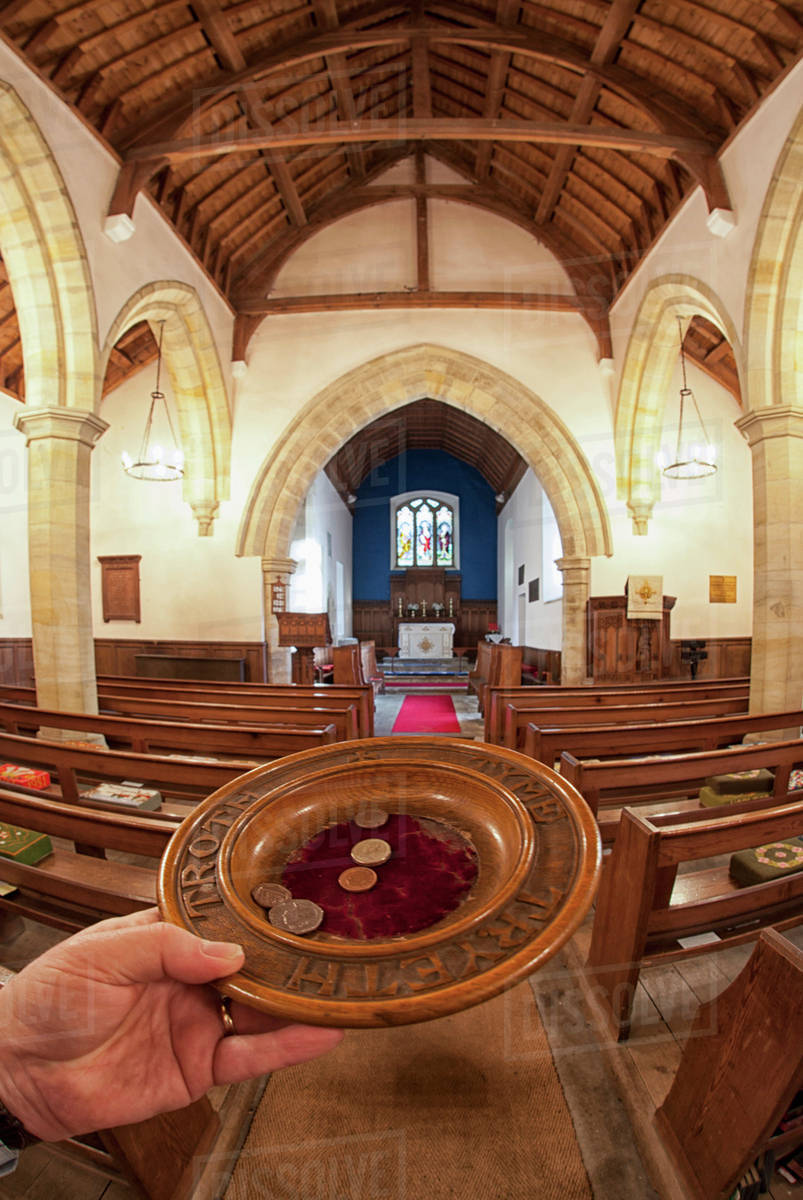 A Hand Holds An Offering Plate At The Back Of A Church; Northumberland ...