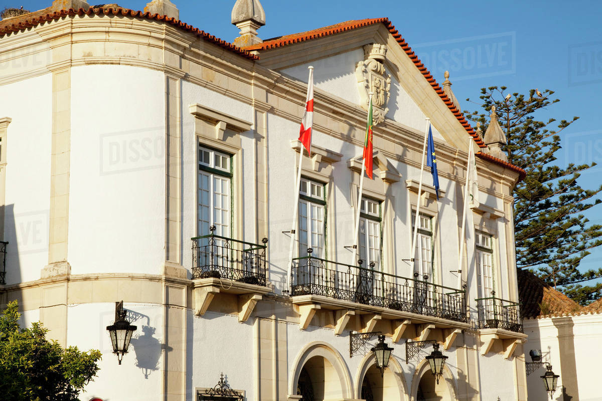 A Building With Flags Lining The Balcony; Faro Algarve, Portugal ...