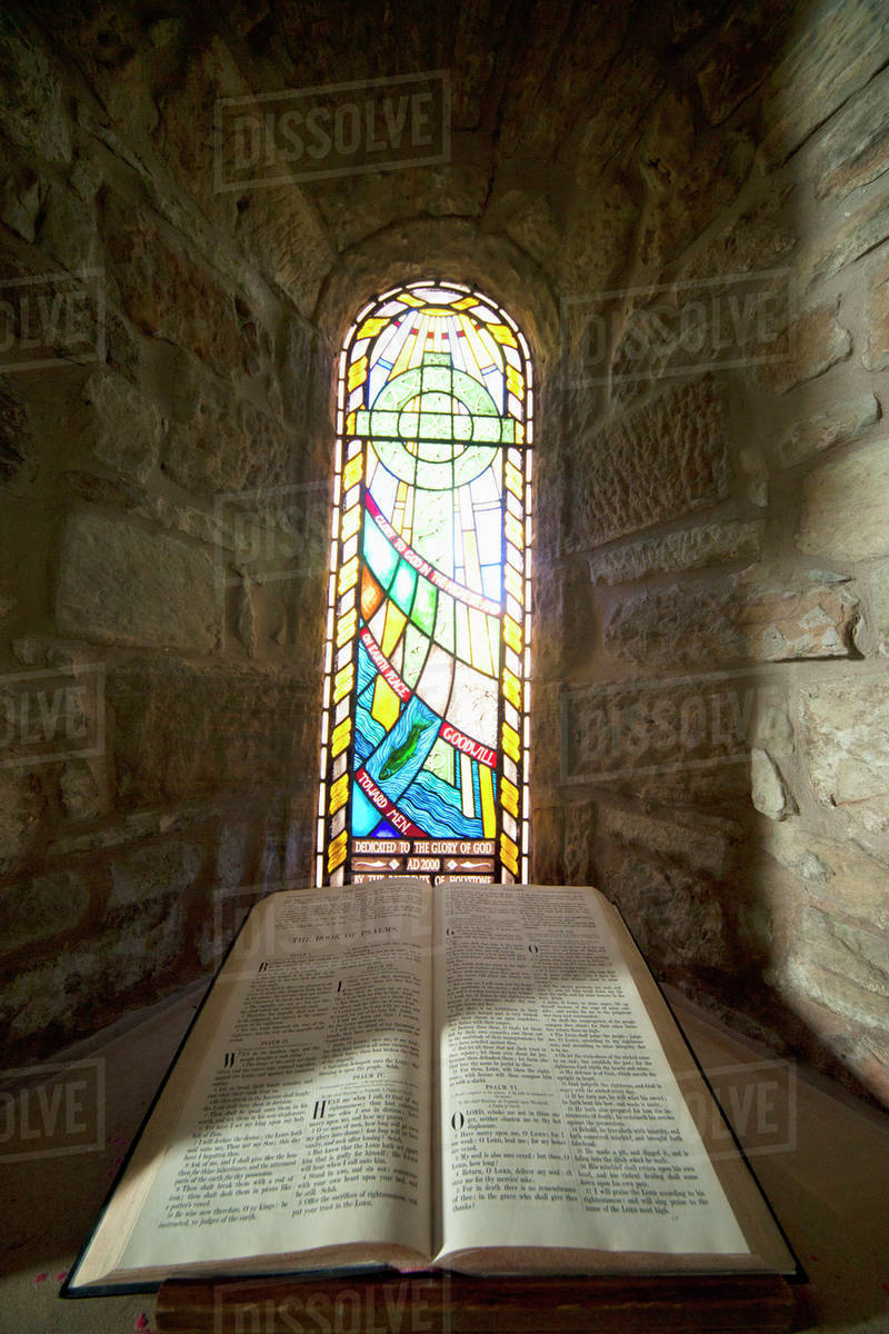 An Open Bible And A Stained Glass Window In St. Mary's Church ...